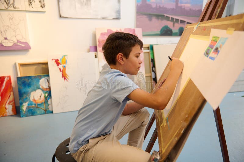 Young Boy Drawing and Painting in Art Class Workshop Stock Photo ...