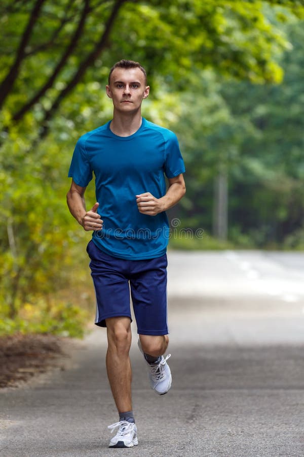 Young Boy Jogging through Forest Stock Photo - Image of person, energy ...