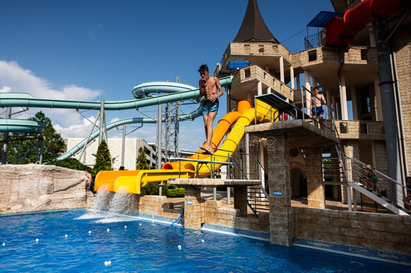 Young Boy Jump and Having Fun on a Water Slide in an Aquapark Stock ...