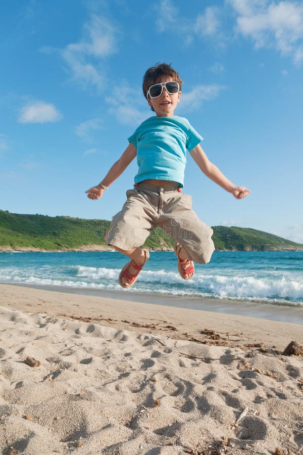 Young boy jump in the sea stock photo. Image of beauty - 26154888