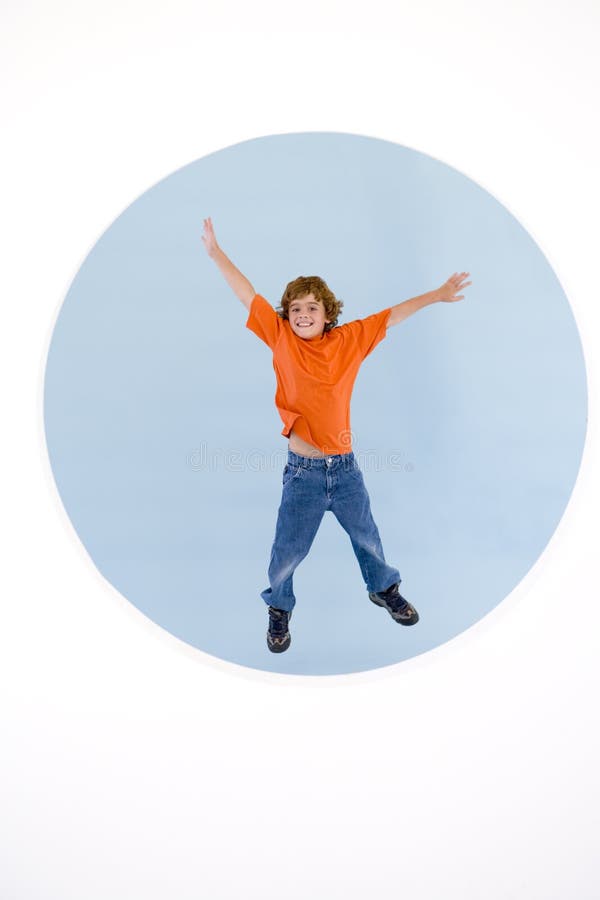 Young Boy Jumping with Arms Out Smiling Stock Photo - Image of child ...