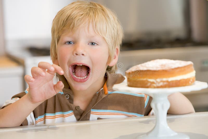Young Boy in Kitchen with Cake on Counter Stock Image - Image of ...