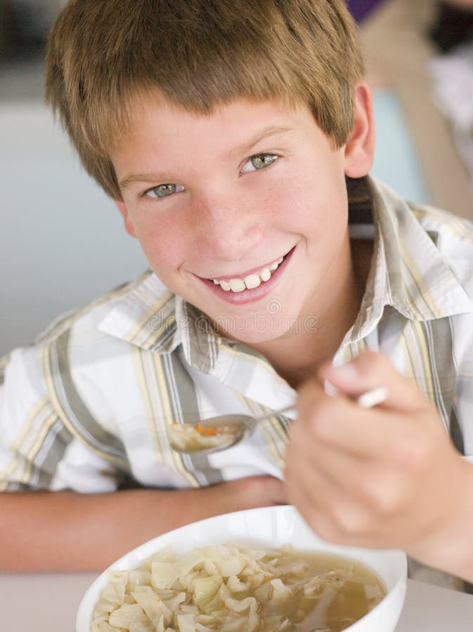 Young Boy in Kitchen Eating Soup and Smiling Stock Image - Image of ...