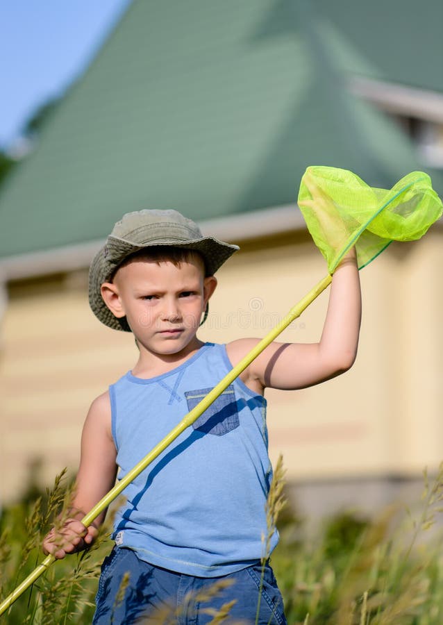 Young Boy Kneeling on Lawn with Bug Net Stock Image - Image of interest ...
