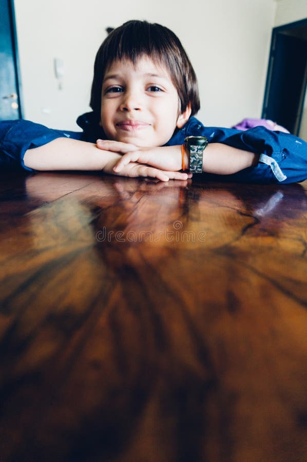 Young boy leaning on table stock image. Image of lean - 63803539