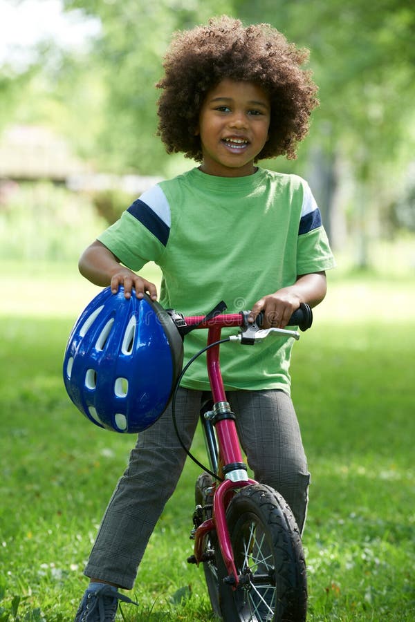 Young Boy Learning To Ride Bike in Park Stock Photo - Image of bike ...
