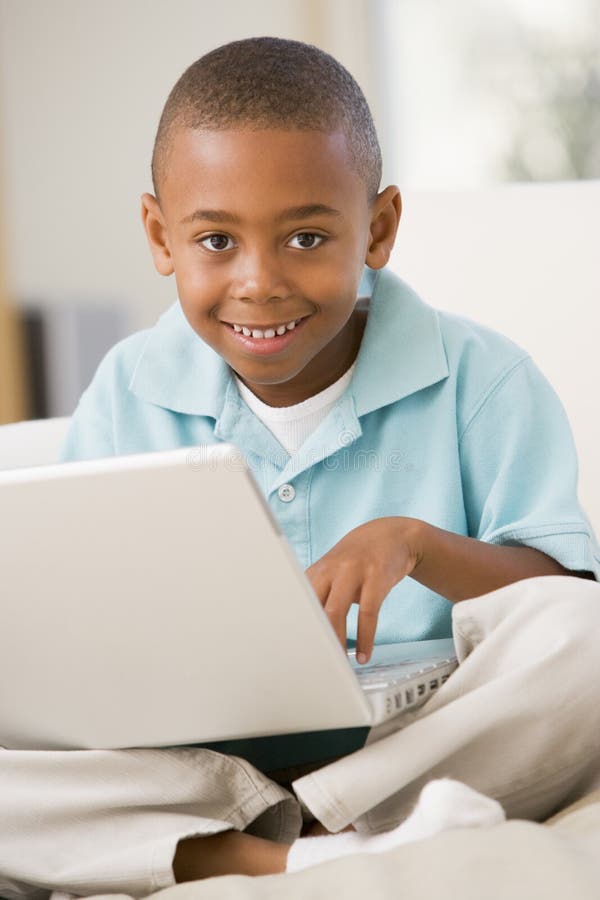 Young Boy in Living Room with Laptop Stock Image - Image of couch ...