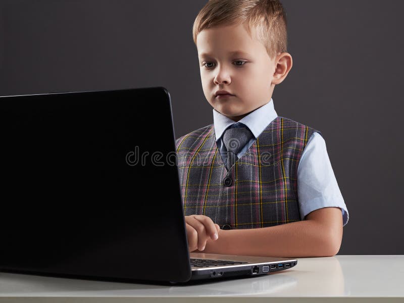 Young Boy with Computer. Funny Child Looking in Notebook Stock Photo ...