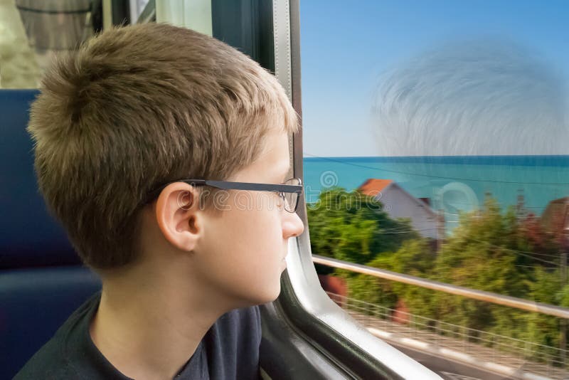 The Young Boy Looks Out of the Window of the Going Train Stock Image ...