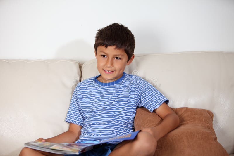 Young boy with magazine stock image. Image of lesson - 32954187