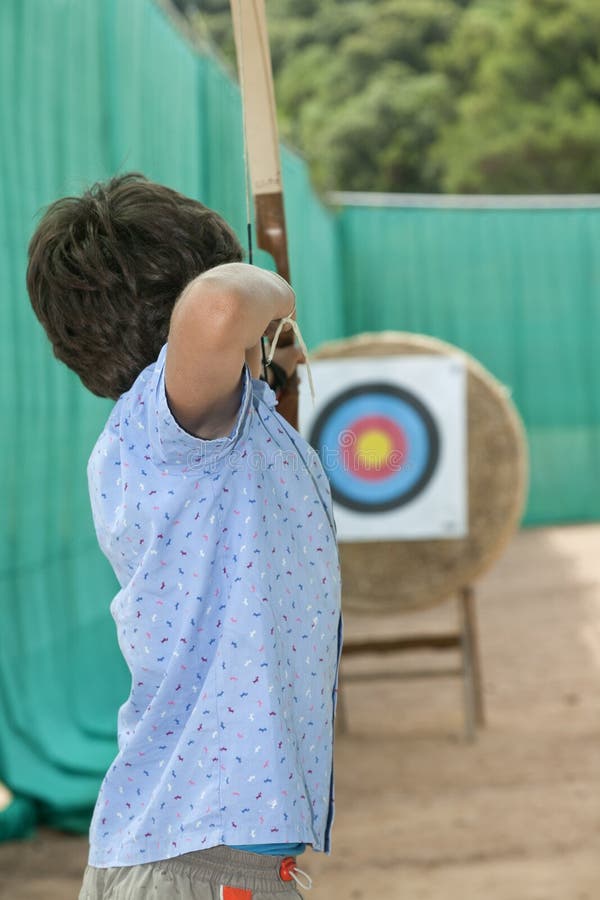 Young boy makes archery stock photo. Image of outside - 25693256