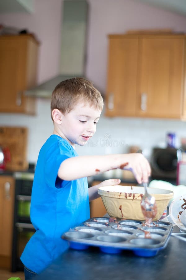 Young Boy Making Chocolate Cakes Stock Photo - Image of cooking, bake ...