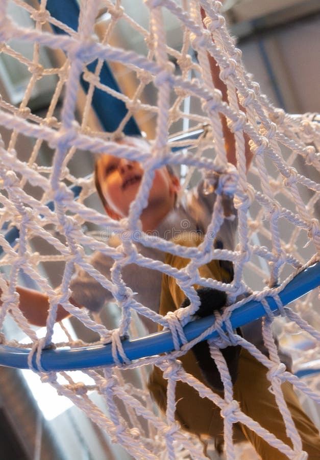 Boy in Net Sleeve of Amusement Park Climbing Facility Stock Image ... Boy in Net Sleeve of Amusement Park Climbing Facility Stock Image ...