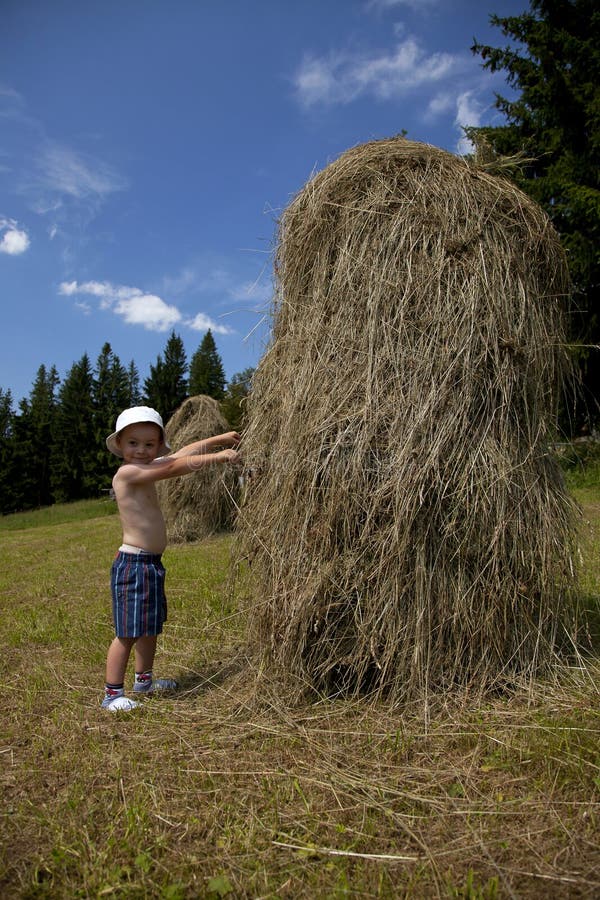Young Boy Next To a Haystack Stock Image - Image of space, haymaking ...