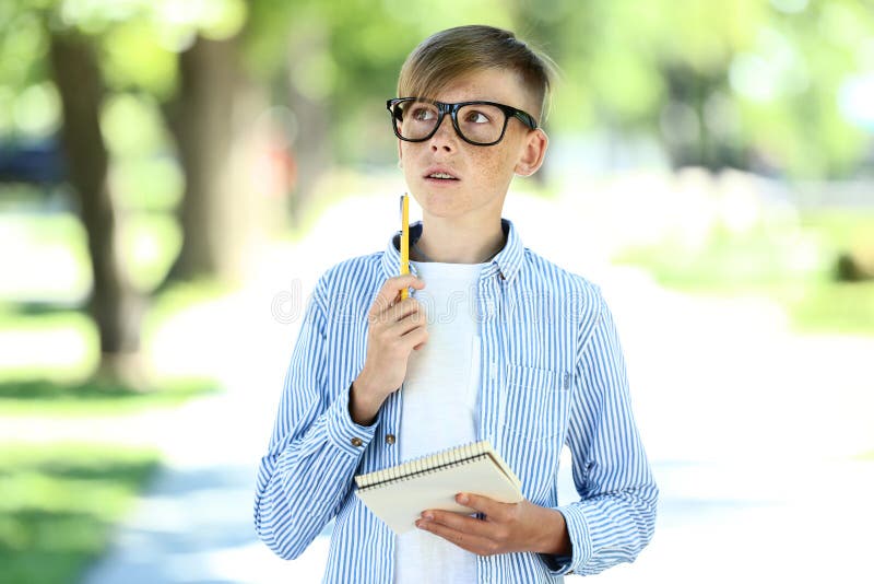 Boy with notebook and pen stock image. Image of cute - 136621551