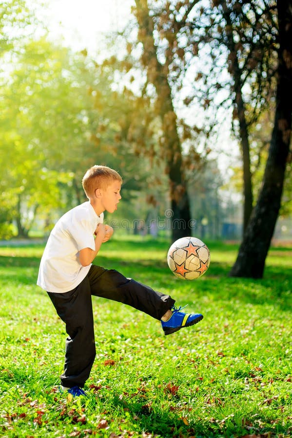 Young boy play football stock image. Image of countryside - 40636827