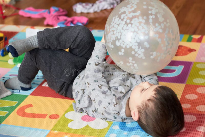 Young Boy Playing with a Balloon in His Room Stock Photo - Image of ...