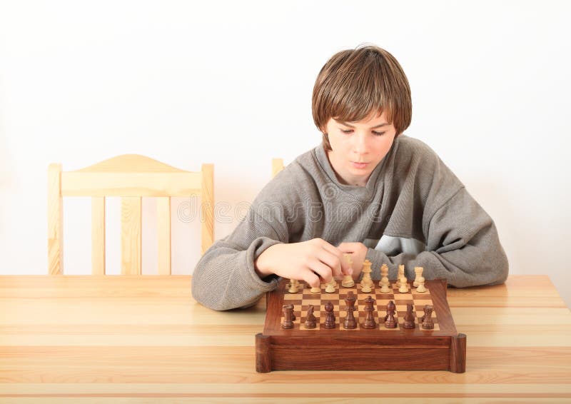 Young boy playing chess stock image. Image of watching - 48808473