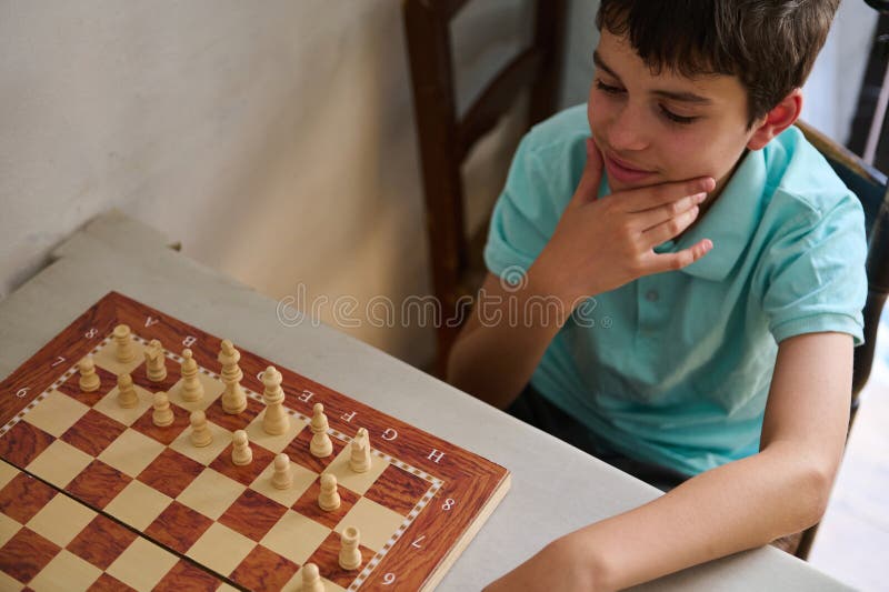 Young Boy Playing Chess and Thinking Deeply about His Next Move Stock ...