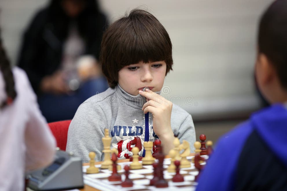 Young boy playing chess editorial stock image. Image of infant - 71621474
