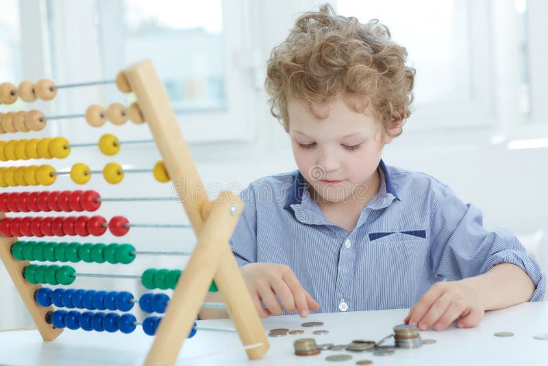 Young Caucasian Curly Boy Playing with Counter and Coins. Stock Photo ...