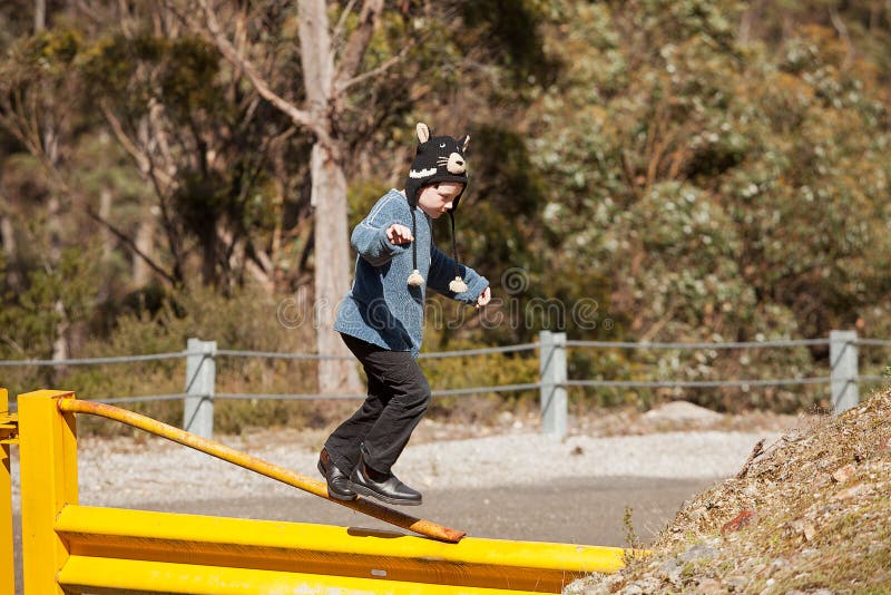 Young Boy Playing on a Gate Stock Photo - Image of industry, industrial ...