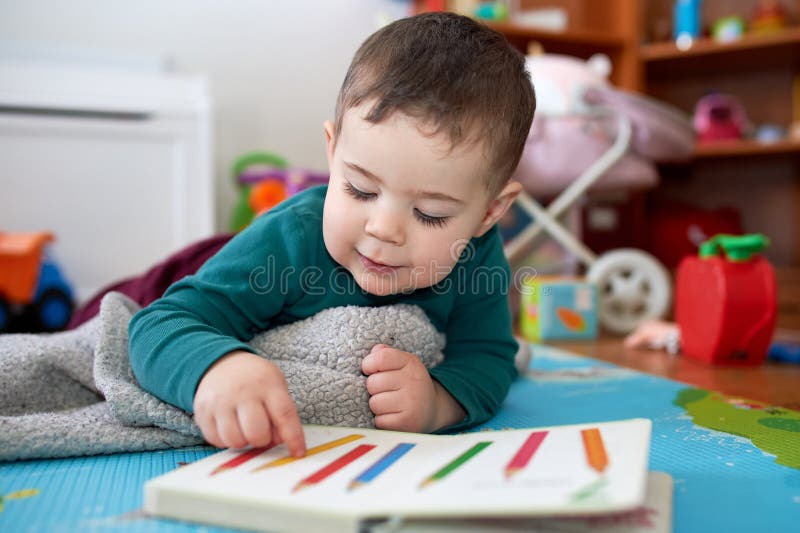Young Boy Playing and Looking at Books in His Room Stock Photo - Image ...