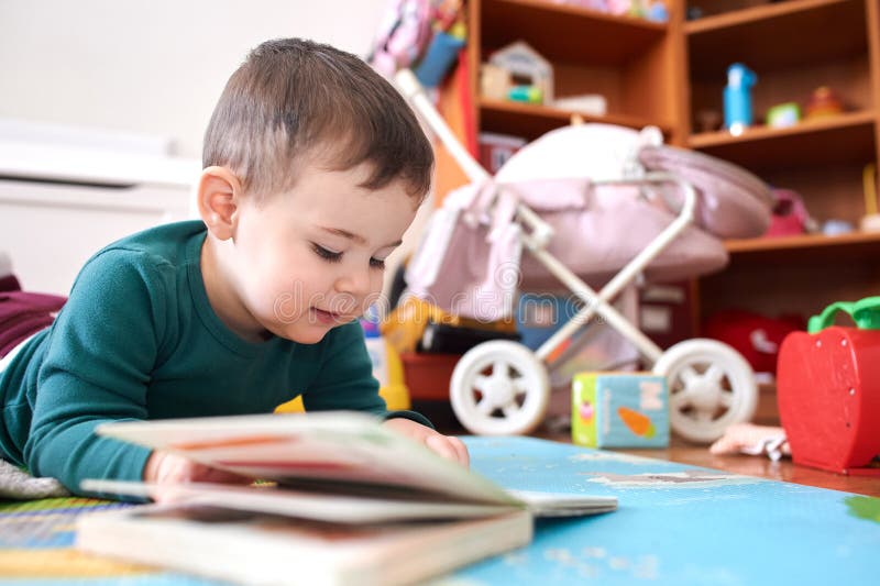 Young Boy Playing and Looking at Books in His Room Stock Photo - Image ...