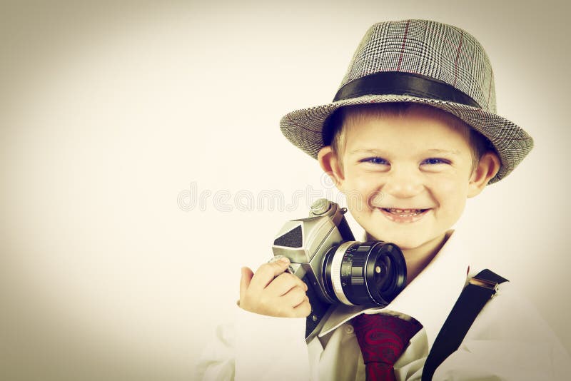 Young Boy Playing with an Old Camera To Be Photographer Stock Image ...