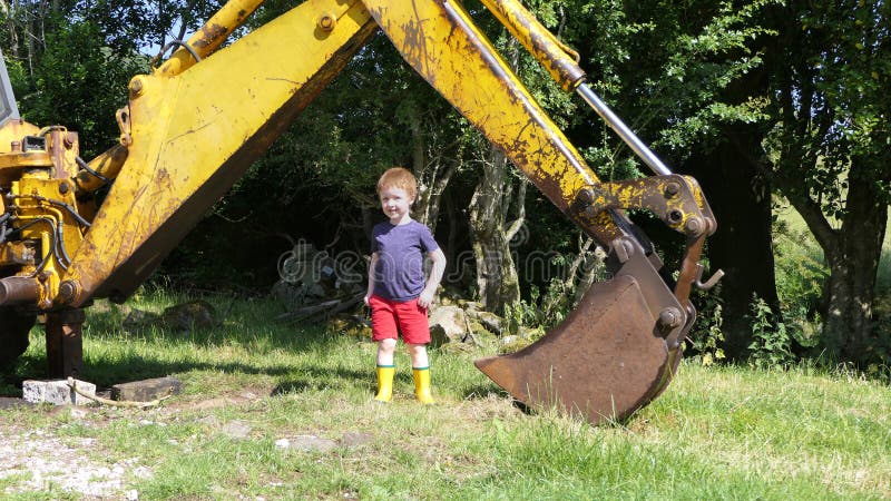 Young Boy Playing in an Old Yellow Digger on the Farm Stock Image ...