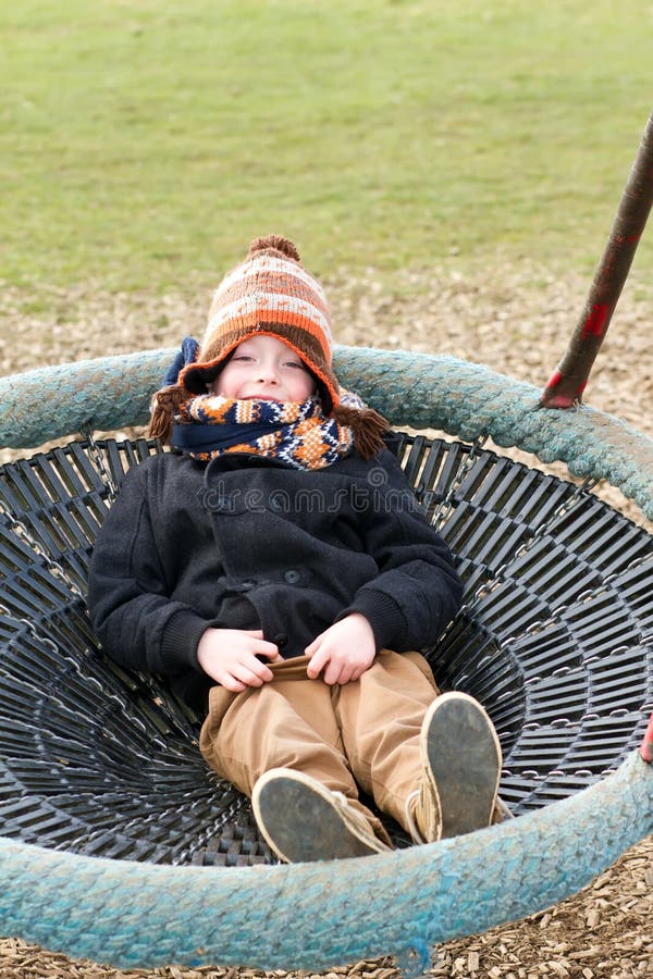 Young Boy Playing at the Park on a Cold Day Stock Photo - Image of ...