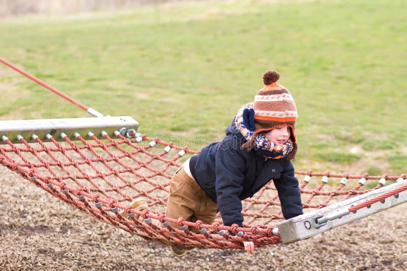 Young Boy Playing at the Park on a Cold Day Stock Photo - Image of ...