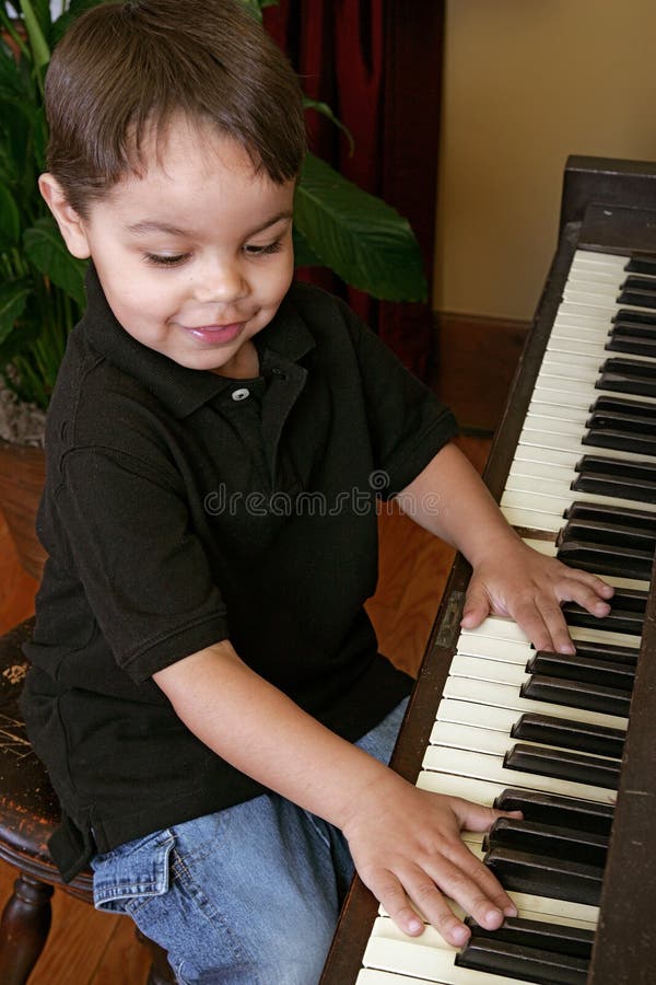 Young boy playing piano stock image. Image of musical - 5308391