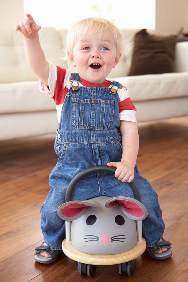 Young Boy Playing with Ride on Toy Mouse at Home Stock Photo - Image of ...