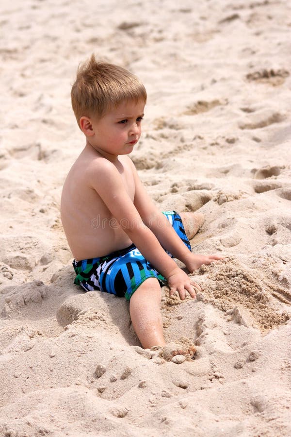 Young Boy Playing with Sand Stock Photo - Image of sand, shore: 17692596