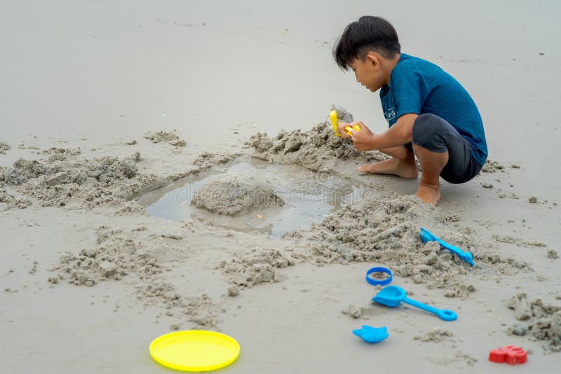 A Young Boy Playing Sand at the Beach - Close Up Photo of the Sand ...