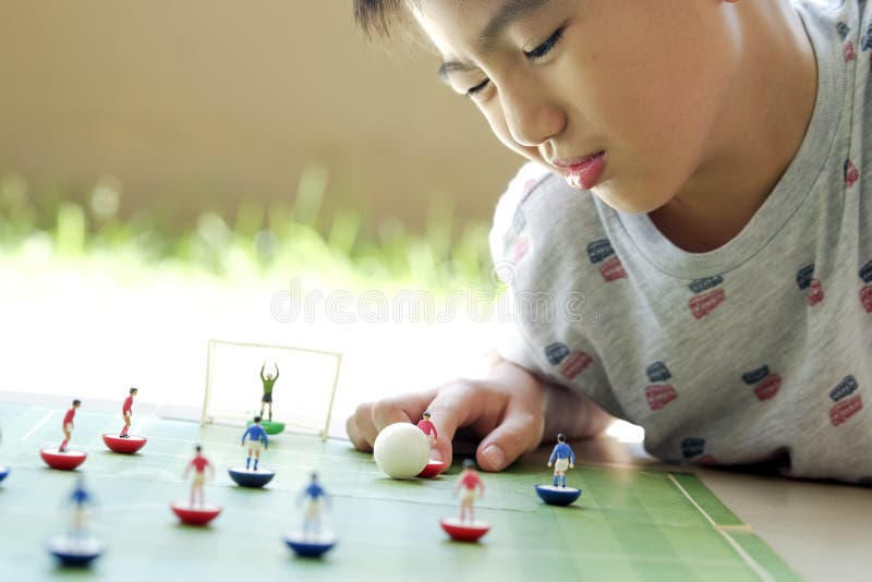 Young Boy Playing Table Soccer Board Game Stock Photo - Image of space ...