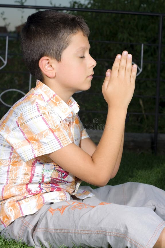 Young boy praying outdoors stock photo. Image of diverse - 6092700