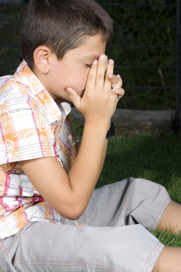 Young Boy Praying Outdoors Picture. Image: 6092701
