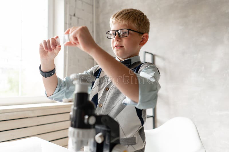Young Boy Preparing Samples for Examination Under Microscope Stock ...