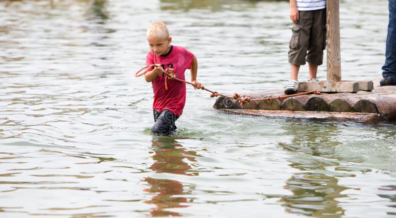 Young Boy is Pulling a Raft Stock Image - Image of little, rope: 10490345
