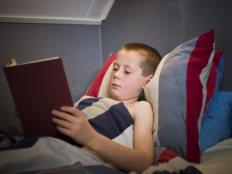 Young Boy reading a book stock image. Image of intelligence - 17022609
