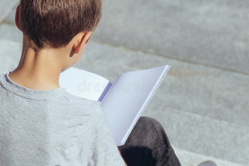 Young Boy Reading Book Outdoors Stock Photo - Image of homework ...