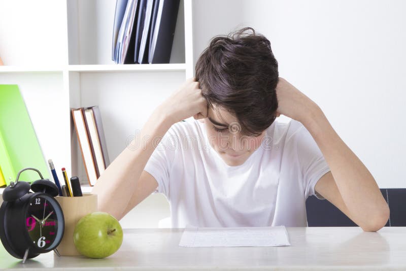 Boy reading at desk stock image. Image of papers, educating - 134326877