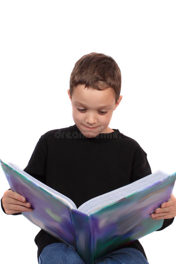 Young boy reading textbook stock photo. Image of hard - 18244640