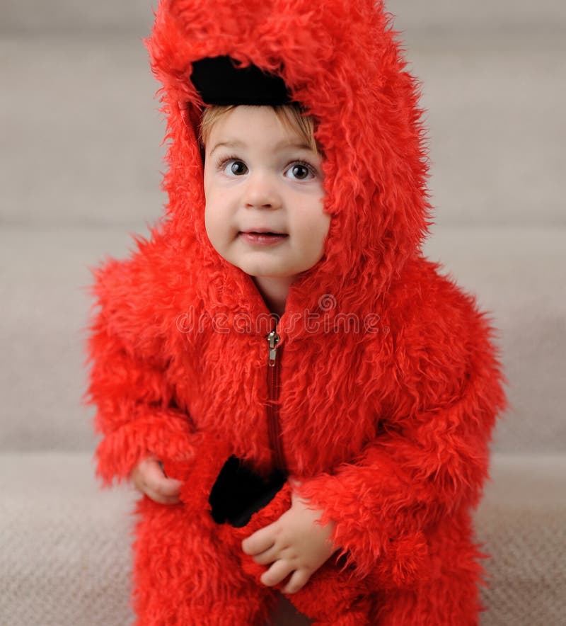 Young Boy in Red Fluffy Costume Stock Photo - Image of cemetery, colour ...