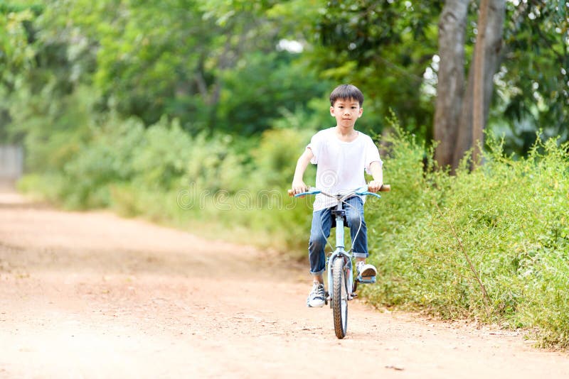 Young boy ride bicycle stock photo. Image of garden, road - 80056080