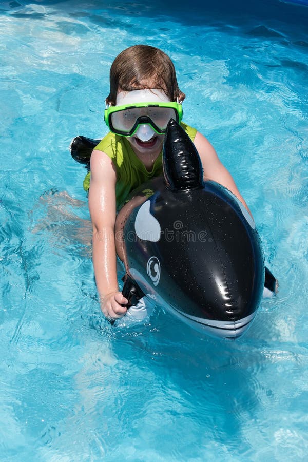 Young Boy Riding Float in Pool Swimming Forward Stock Image - Image of ...
