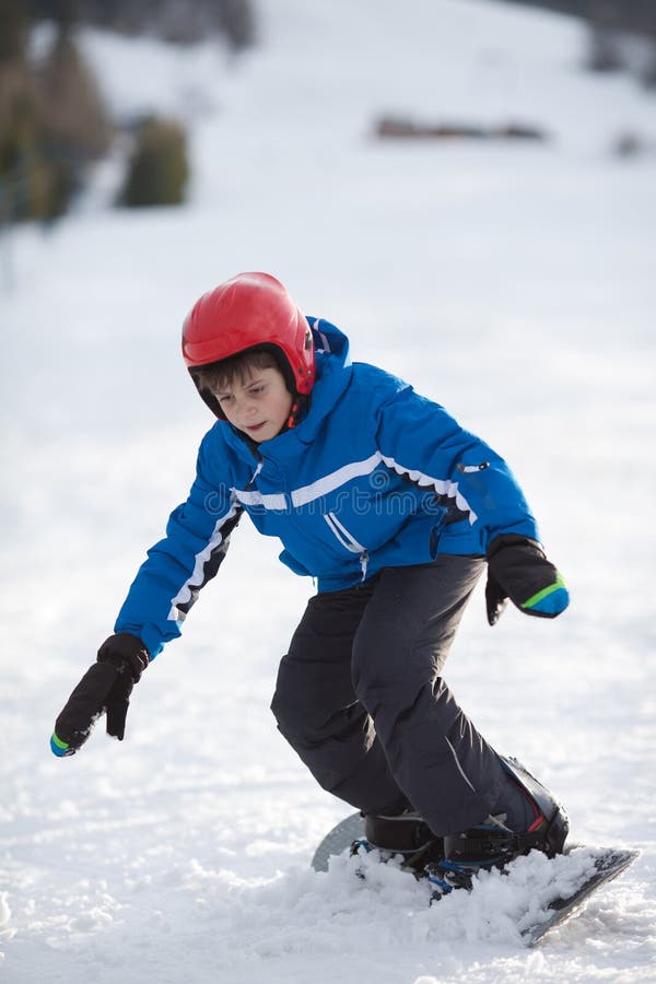 Young boy riding snowboard stock image. Image of exercising - 49432991