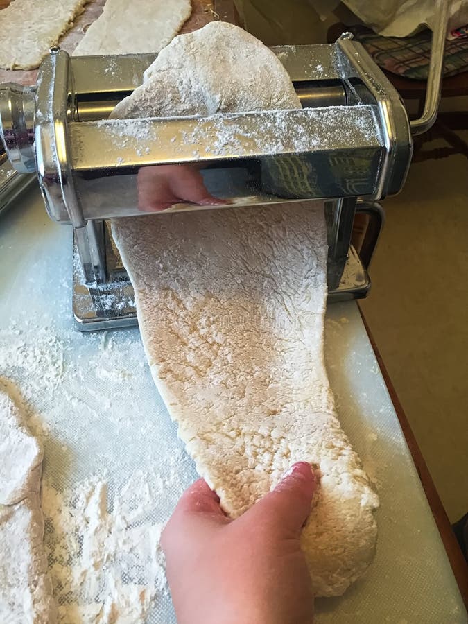 A Young Boy Rolling through a Machine Stock Image - Image of food ...